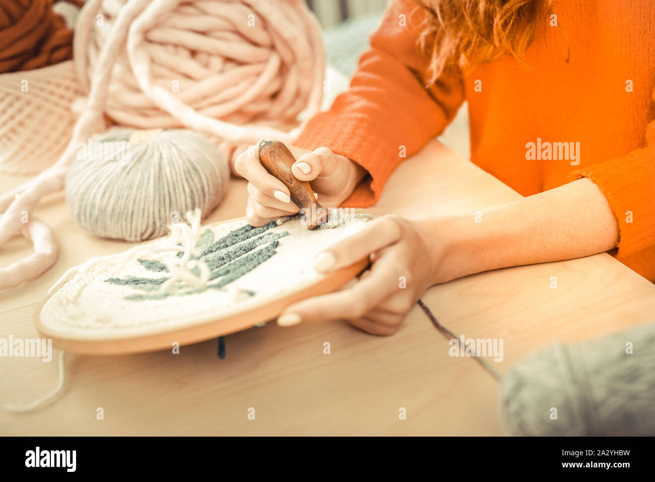 Red- haired girl using professional tools for embroidering Stock Photo ...