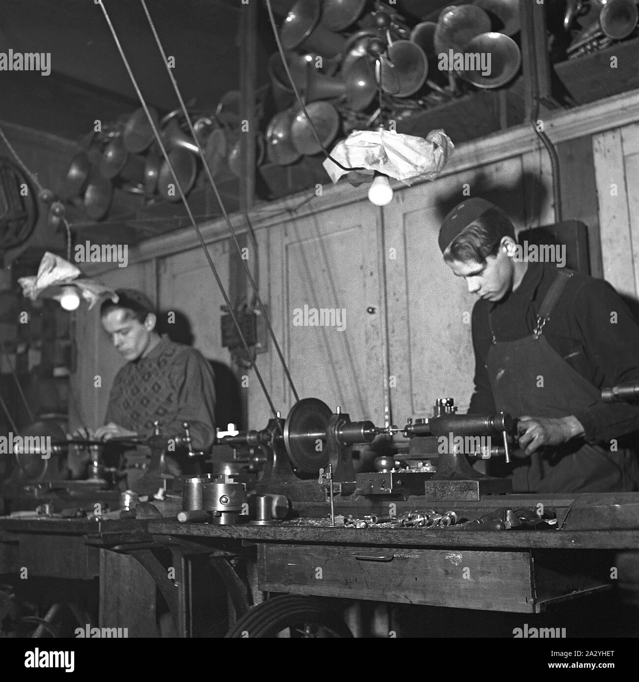 Workers in the 1940s. Interior of a mechanical workshop for musical ...