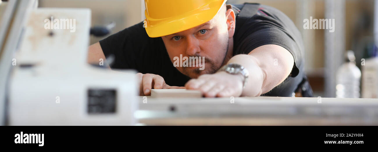 Worker using electric saw portrait Stock Photo - Alamy