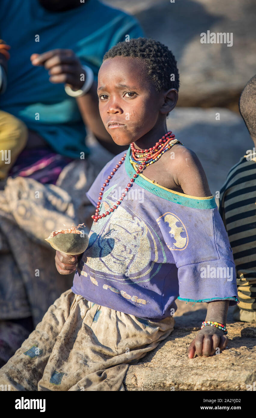 lake Eyasi, Tanzania, 11th September 2019: hadzabe girl eating baobab ...
