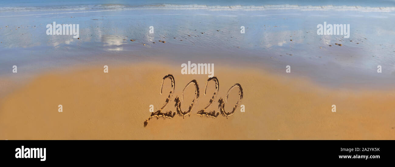 year 2020 handwritten on the sand in front of the sea Stock Photo - Alamy