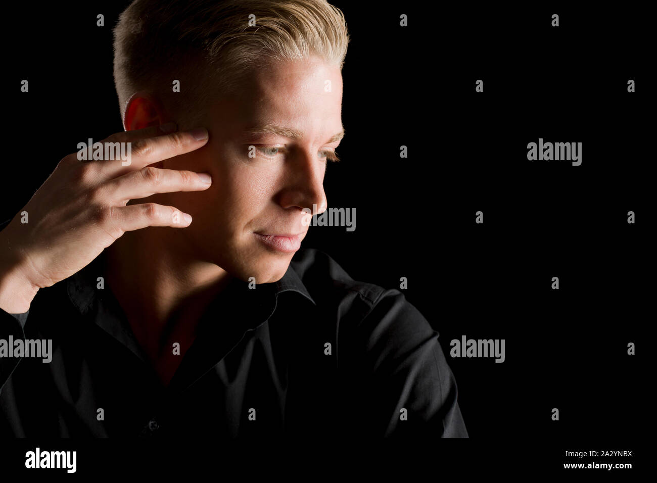 Low key portrait of handsome man looking aside Stock Photo - Alamy