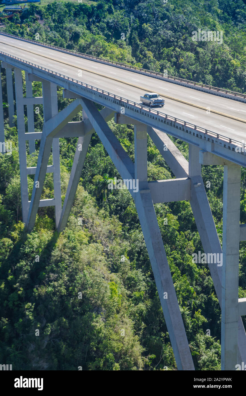 View of the bridge Puente de Bacunayagua with typical Cuban vintage car ...