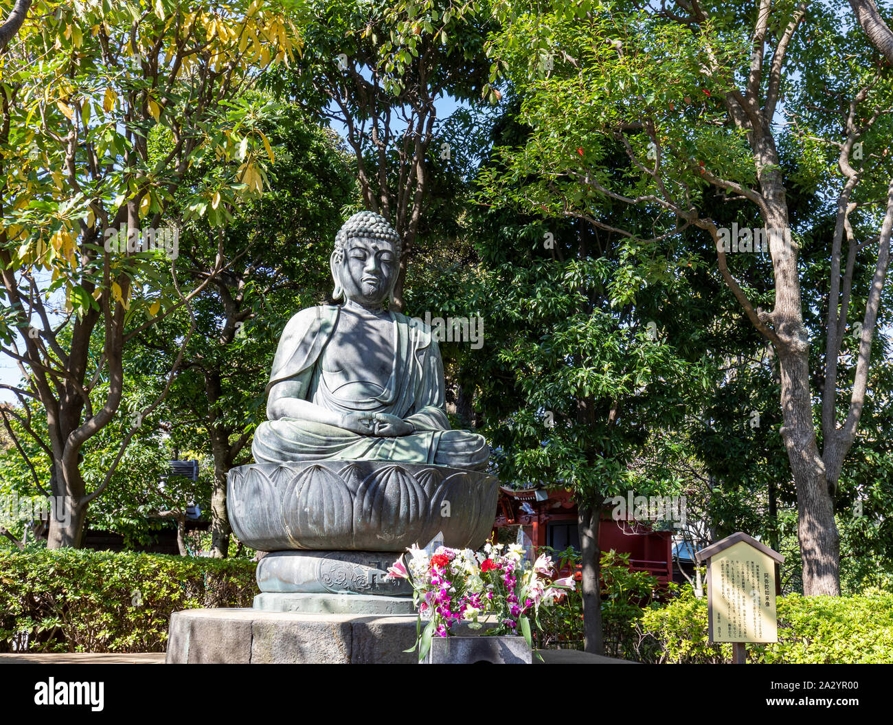 Tokyo, Japan - October 30th, 2018: A Buddha statue in the garden beside ...
