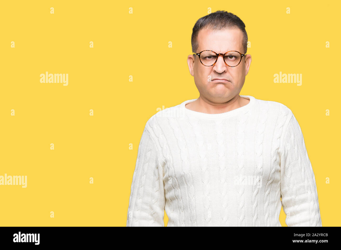 Middle age arab man wearing glasses over isolated background skeptic ...