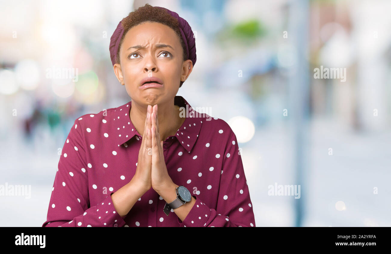 Beautiful young african american woman wearing head scarf over isolated ...