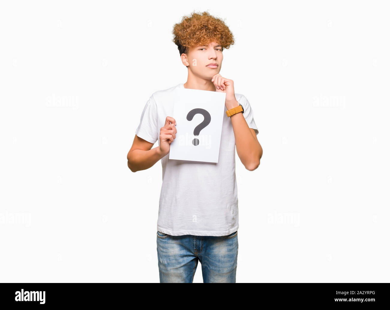 Young handsome man holding paper with question mark serious face ...