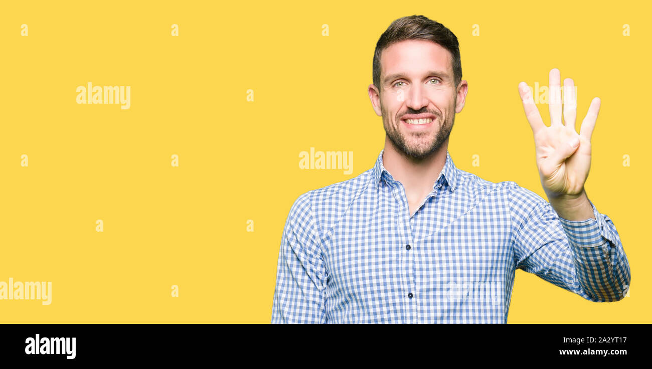 Handsome business man with blue eyes showing and pointing up with ...