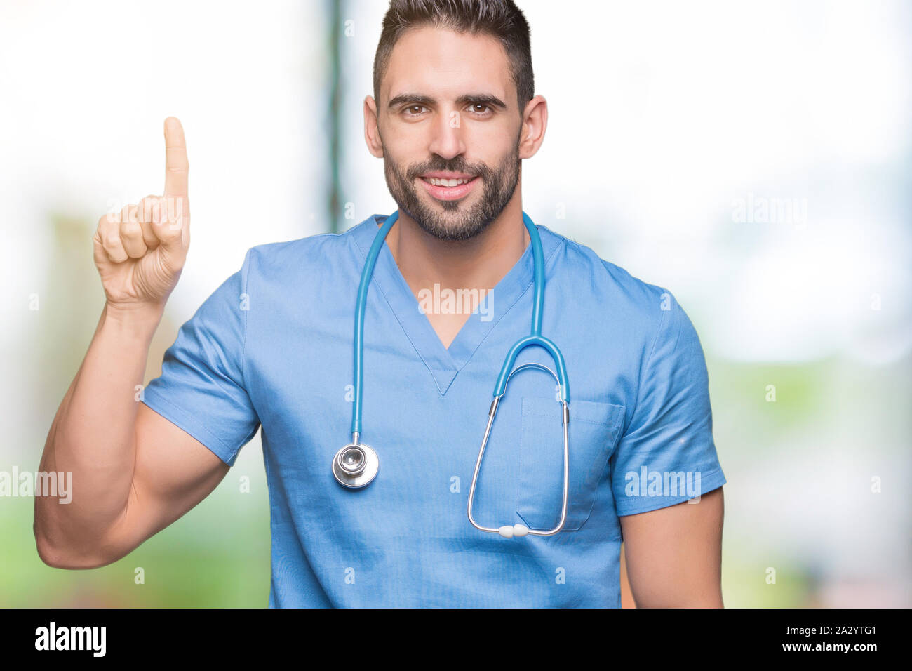 Handsome young doctor surgeon man over isolated background showing and ...