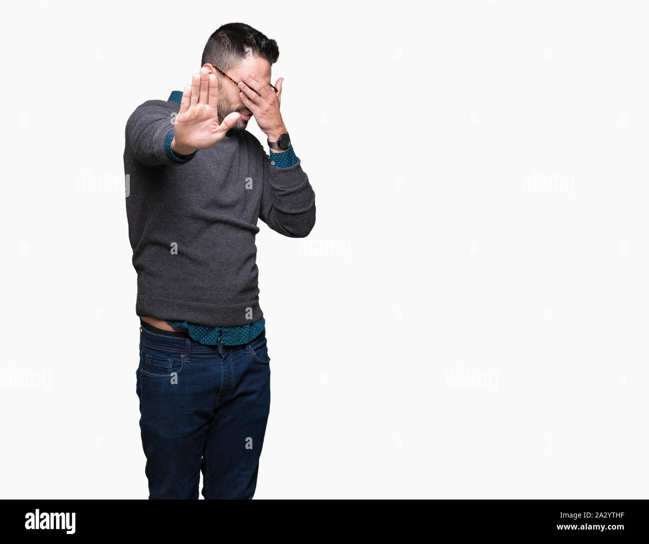 Young handsome man wearing glasses over isolated background covering ...