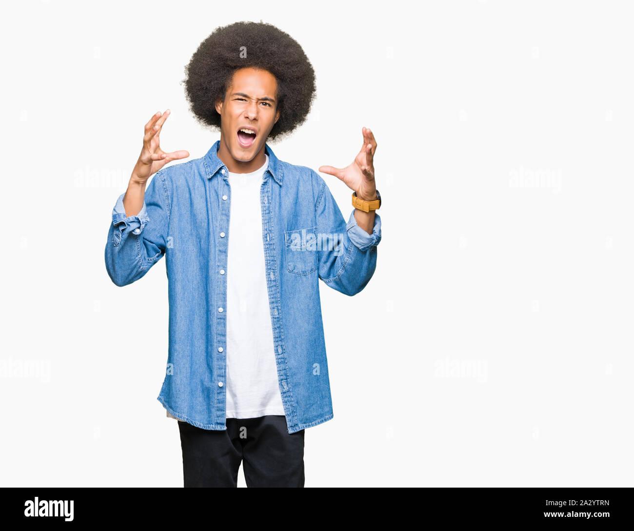 Young african american man with afro hair Shouting frustrated with rage ...