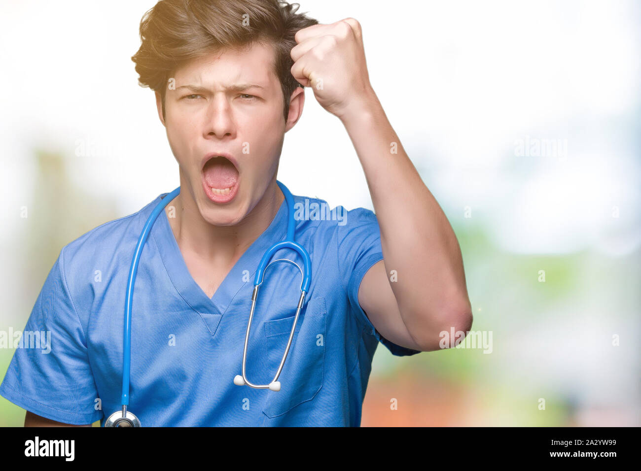 Young doctor wearing medical uniform over isolated background angry and ...