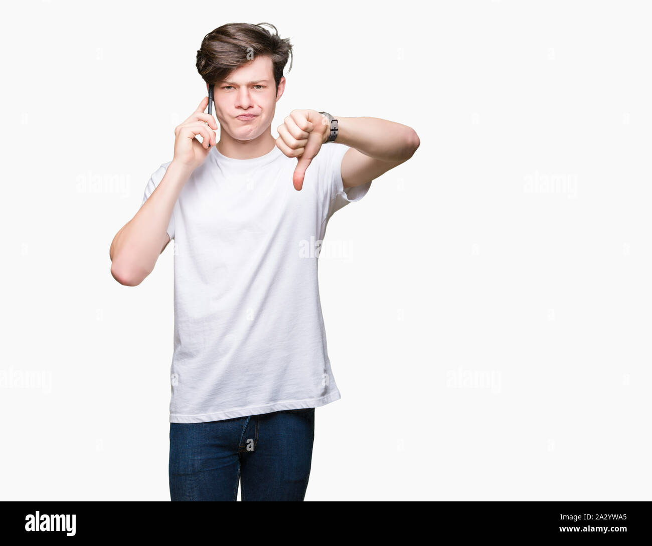 Young man talking on smartphone over isolated background with angry ...