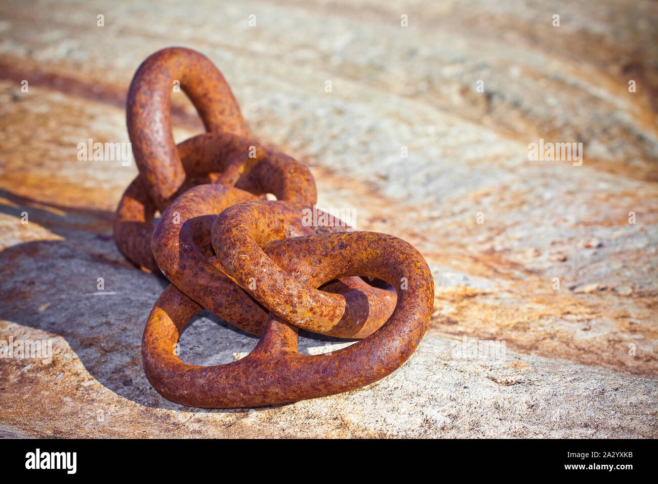 Detail of an old rusty metal chain anchored to a concrete block Stock ...