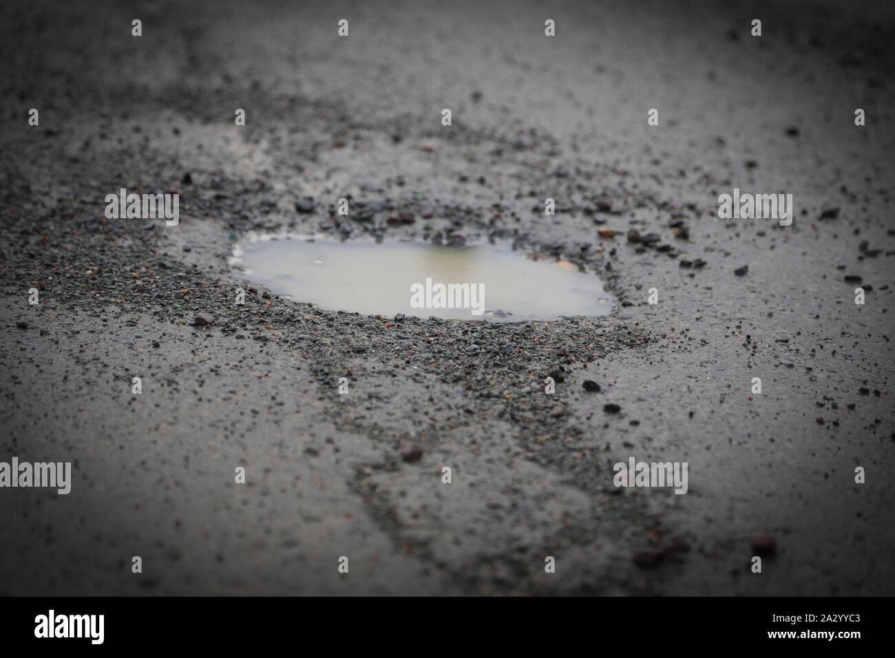 Deep potholes in an old road in need of maintenance Stock Photo - Alamy