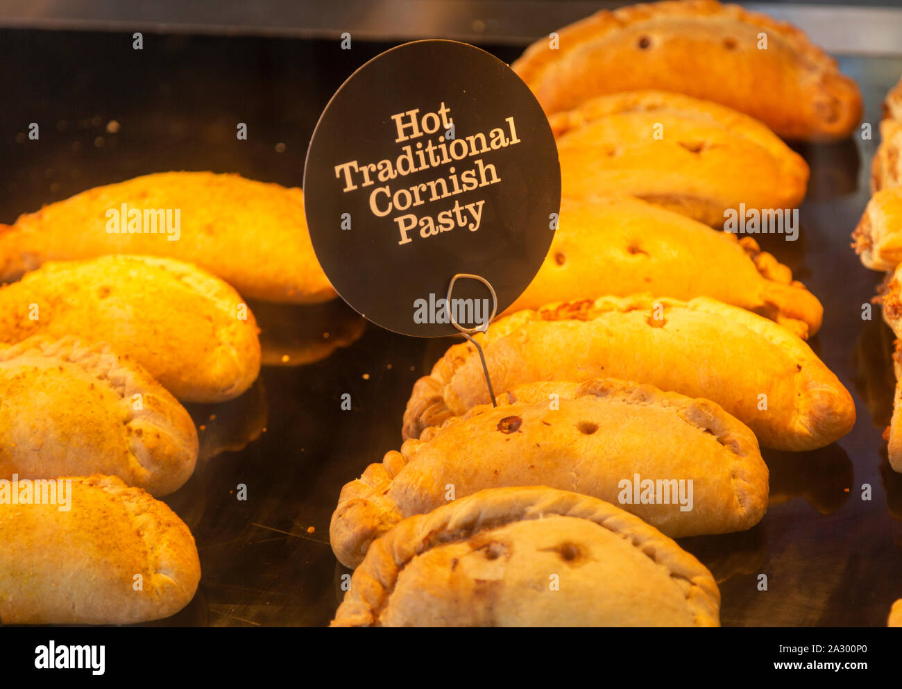 Hot traditional Cornish pasty in display cabinet inside bakery shop, UK ...
