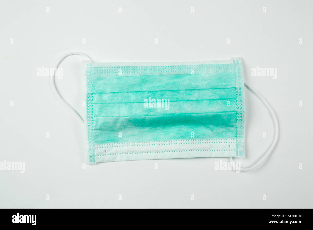 medical mask of blue color on white isolated background Stock Photo - Alamy