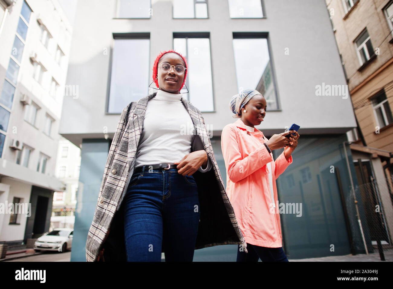Two young modern fashionable, attractive, tall and slim african muslim ...