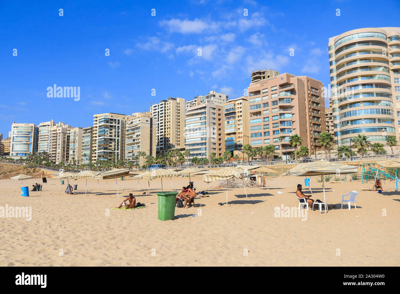 People sunbath at the beach on a hot and sunny day in Beirut Stock ...