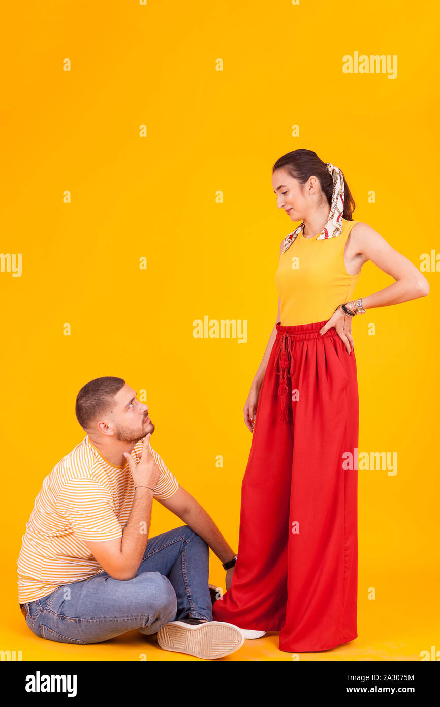 Attractive boyfriend looking up at his beautiful girl while smiling at ...