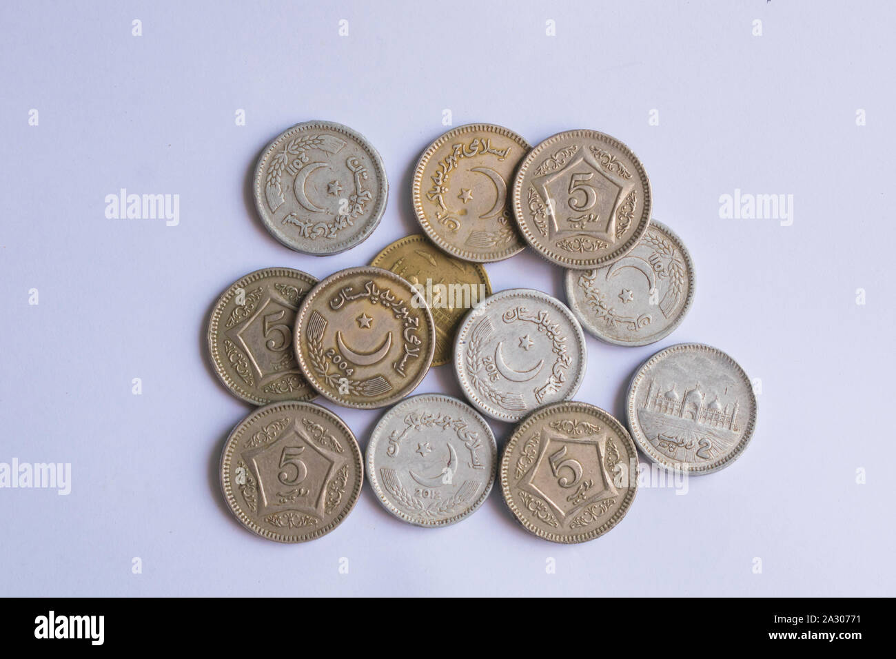 close up of pile of pakistani five rupee coins isolated on white ...