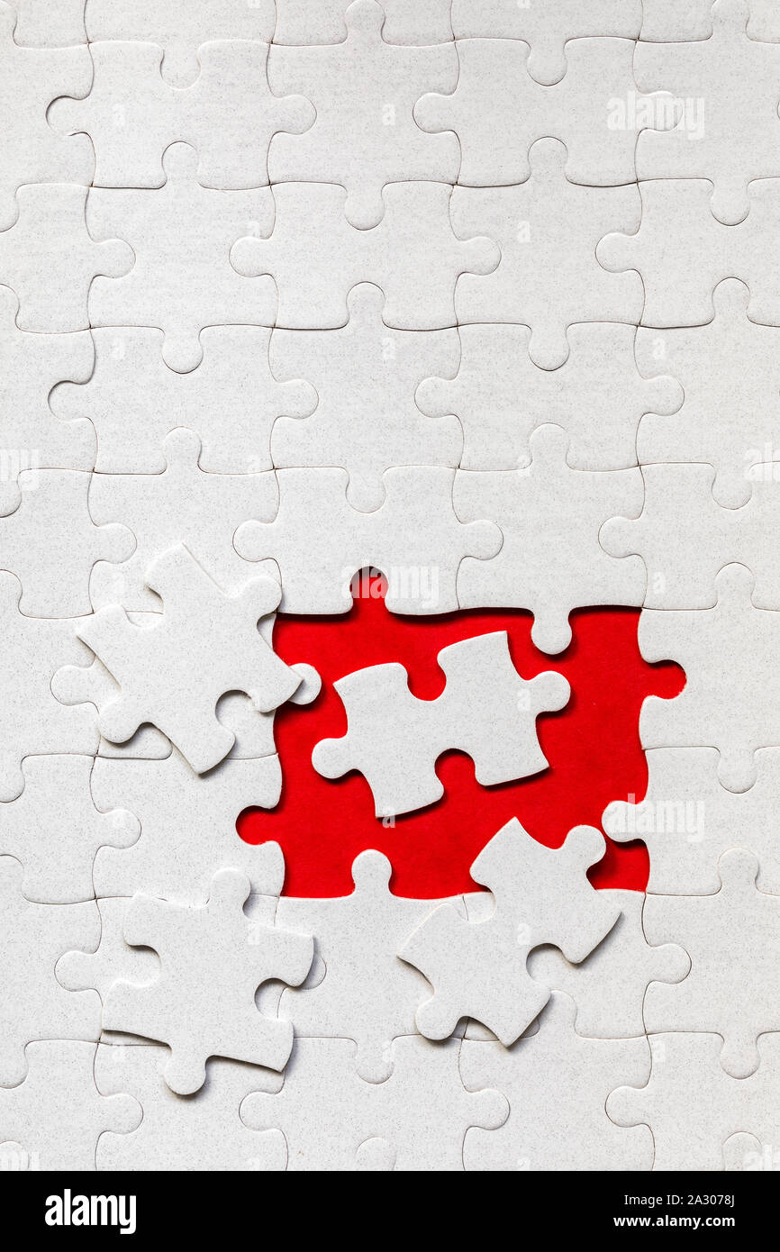 Unfinished white jigsaw puzzle pieces. Fill in pieces of the jigsaw ...