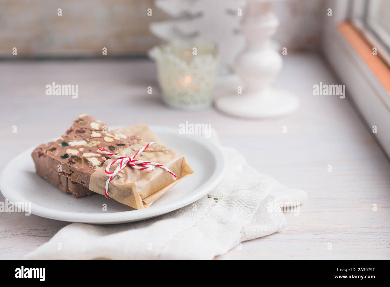 Festive chocolate block tied with string with festive winter decor in ...