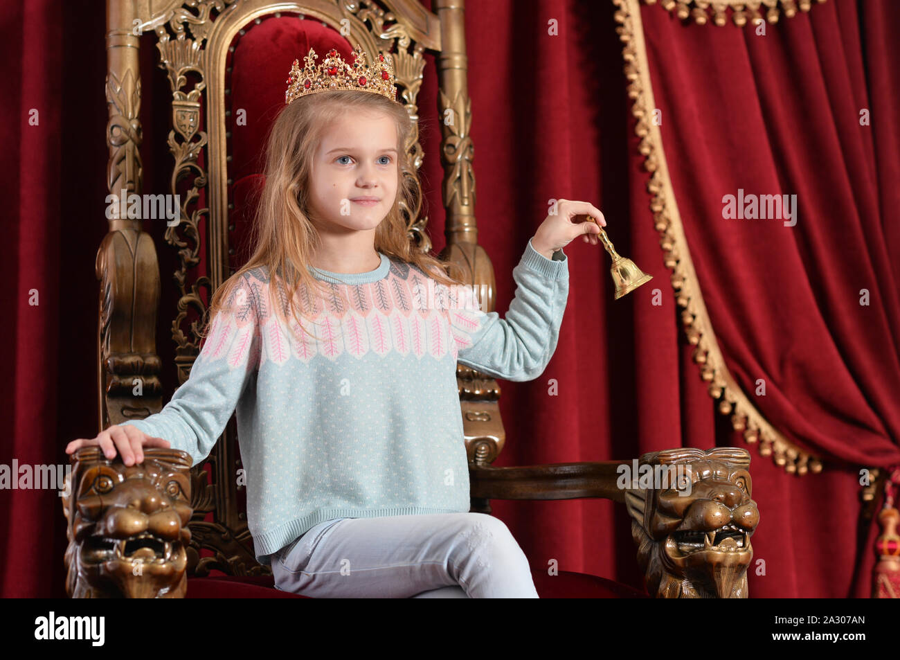 Happy little girl princess posing on throne Stock Photo - Alamy
