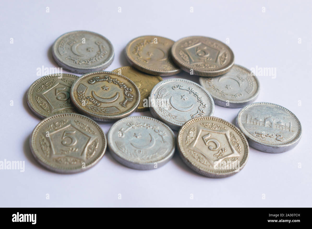 close up of pile of pakistani five rupee coins isolated on white ...