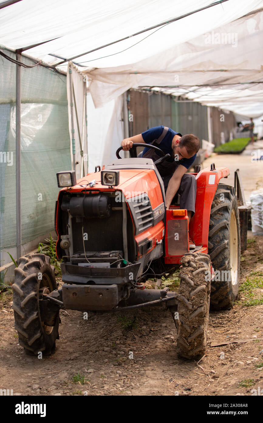 Farmer sitting on a tractor hi-res stock photography and images - Alamy
