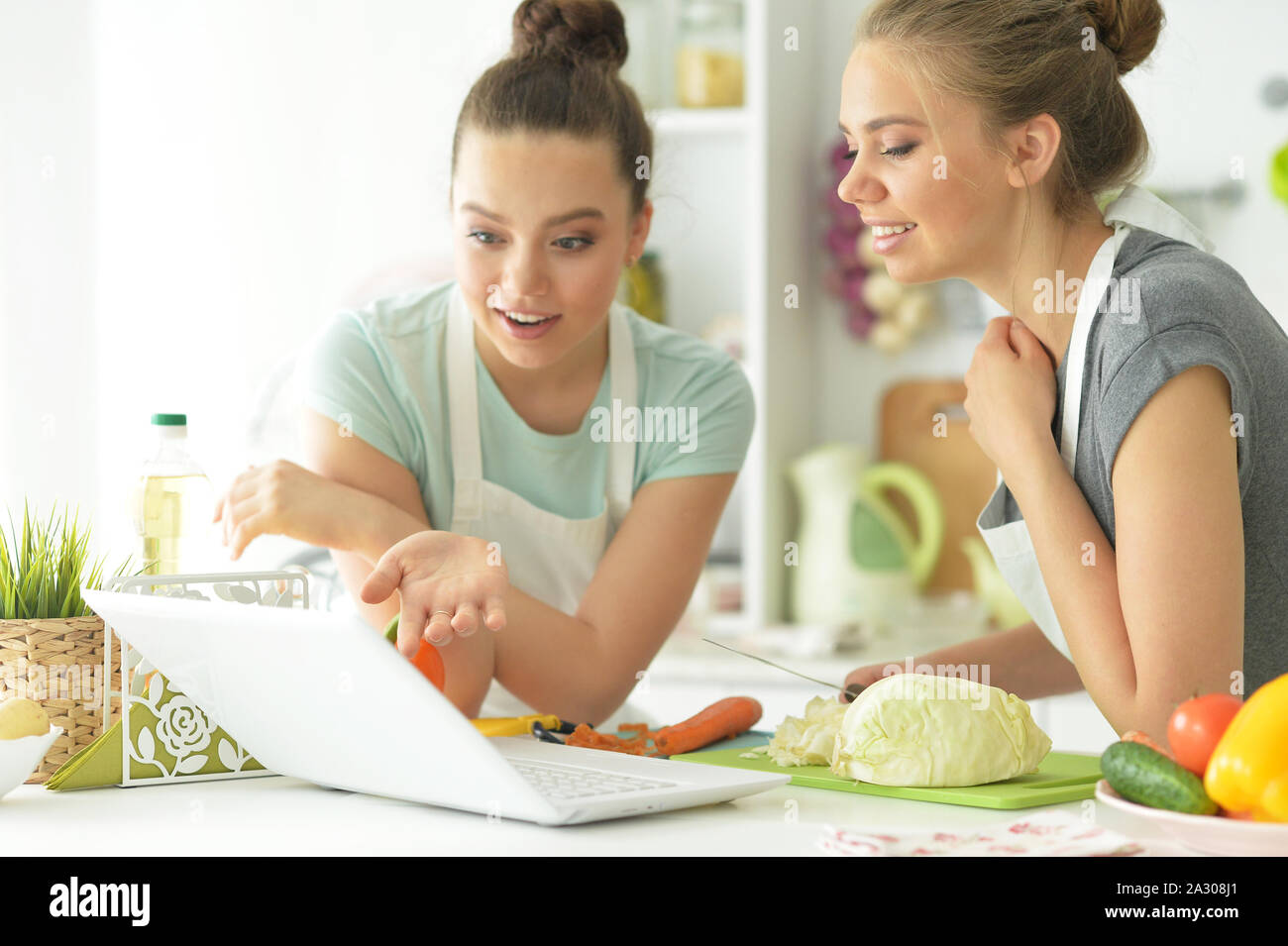 Portrait of beautiful teenagers cooking in kitchen Stock Photo - Alamy