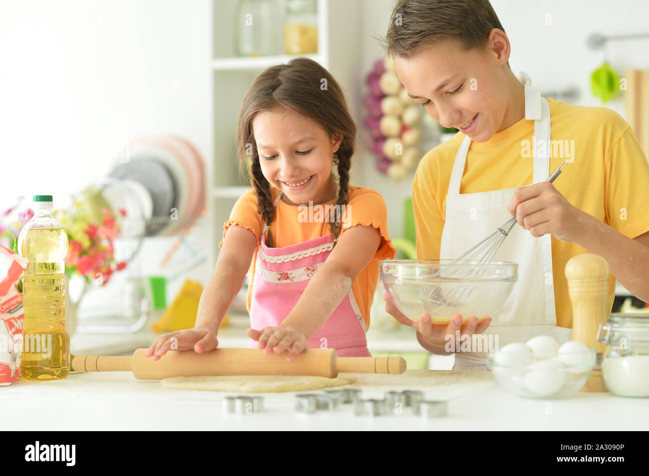 Brother and sister baking together in the kitchen Stock Photo - Alamy