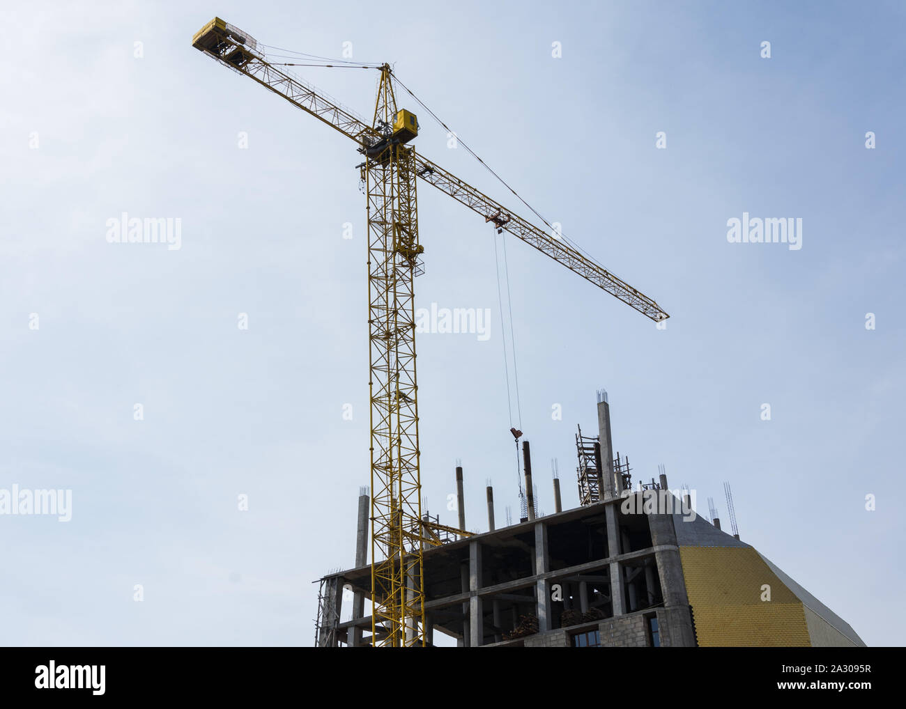 Construction with crane on blue sky background. Crane on construction ...