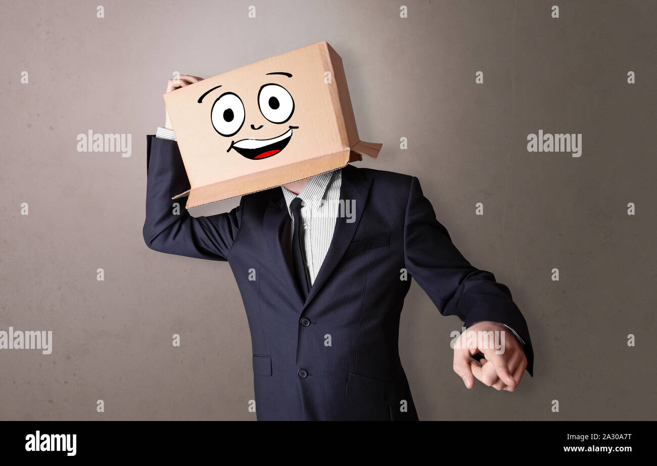 Young boy standing and gesturing with a cardboard box on his head Stock ...