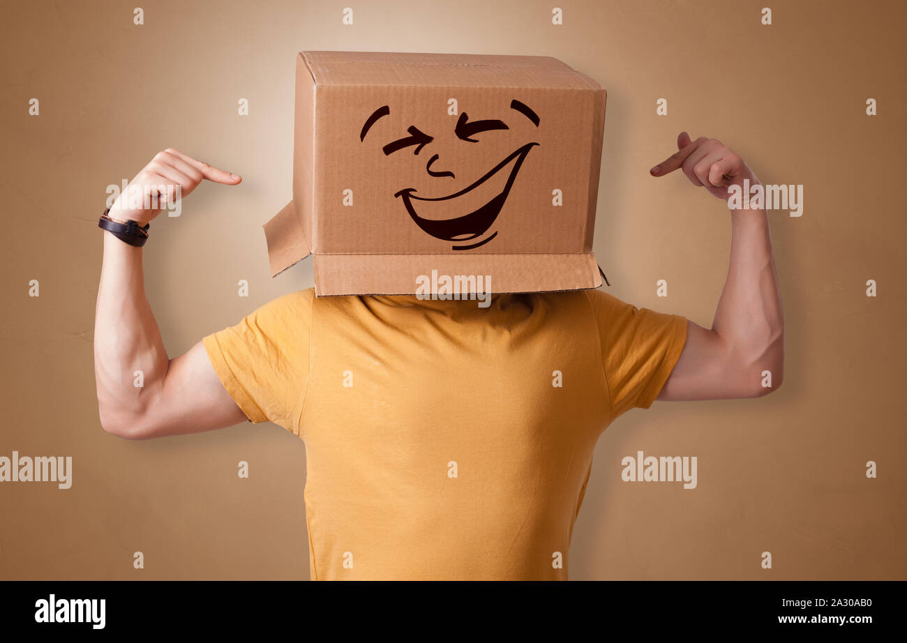 Young boy standing and gesturing with a cardboard box on his head Stock ...