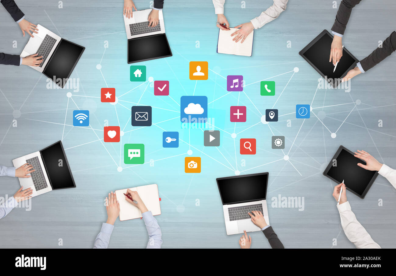 Group of people with devices in hands working in team on tablets ...