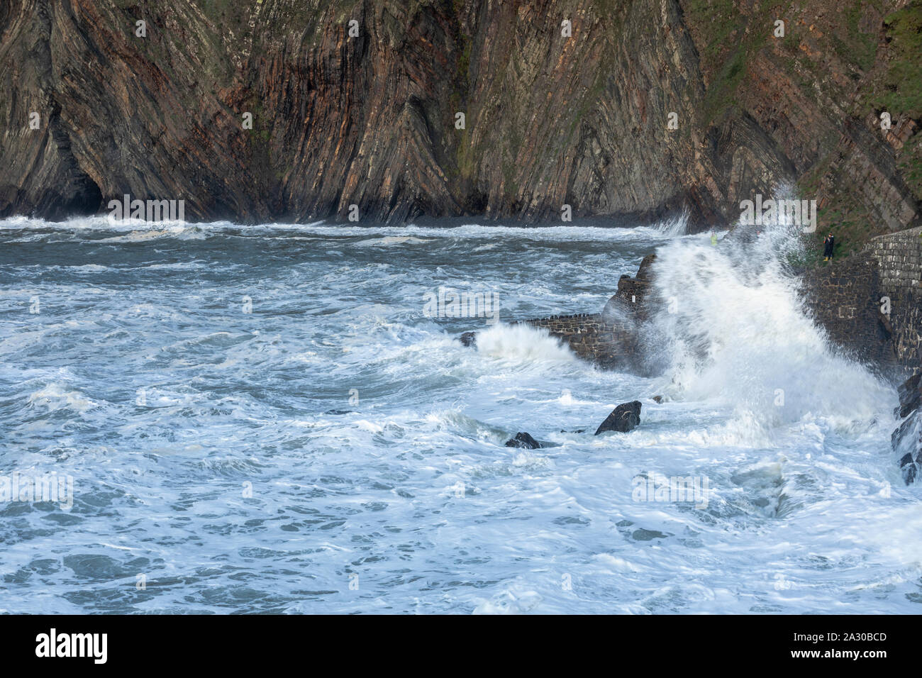 Onlookers watch huge waves crash at Hartland on the north Devon coast ...