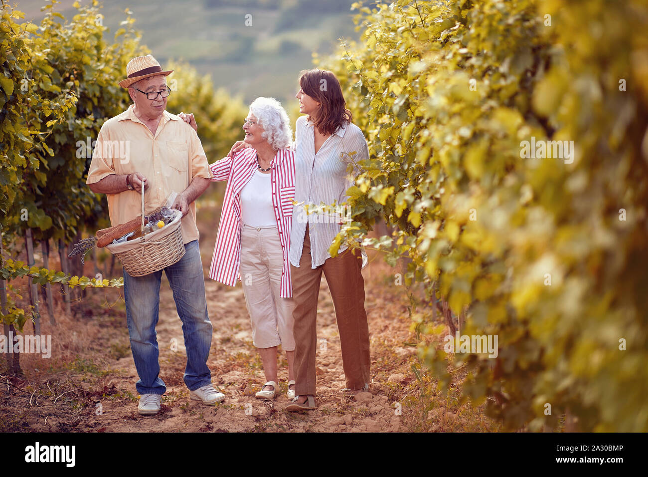 Autumn vineyards. Wine and grapes. Family tradition. Happy family ...