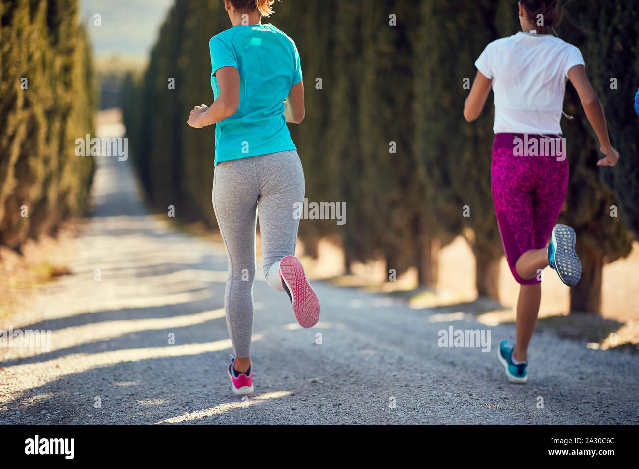 Young sports woman running together outdoors living active healthy ...