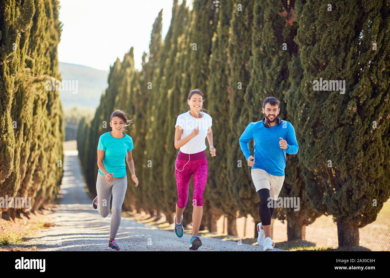 Friends jogging outdoors training together. healthy lifestyle Stock ...