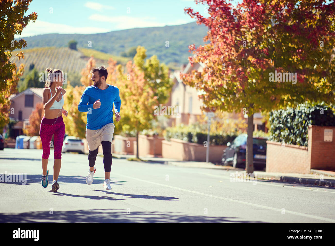smiling couple enjoying at jogging together at city Stock Photo - Alamy