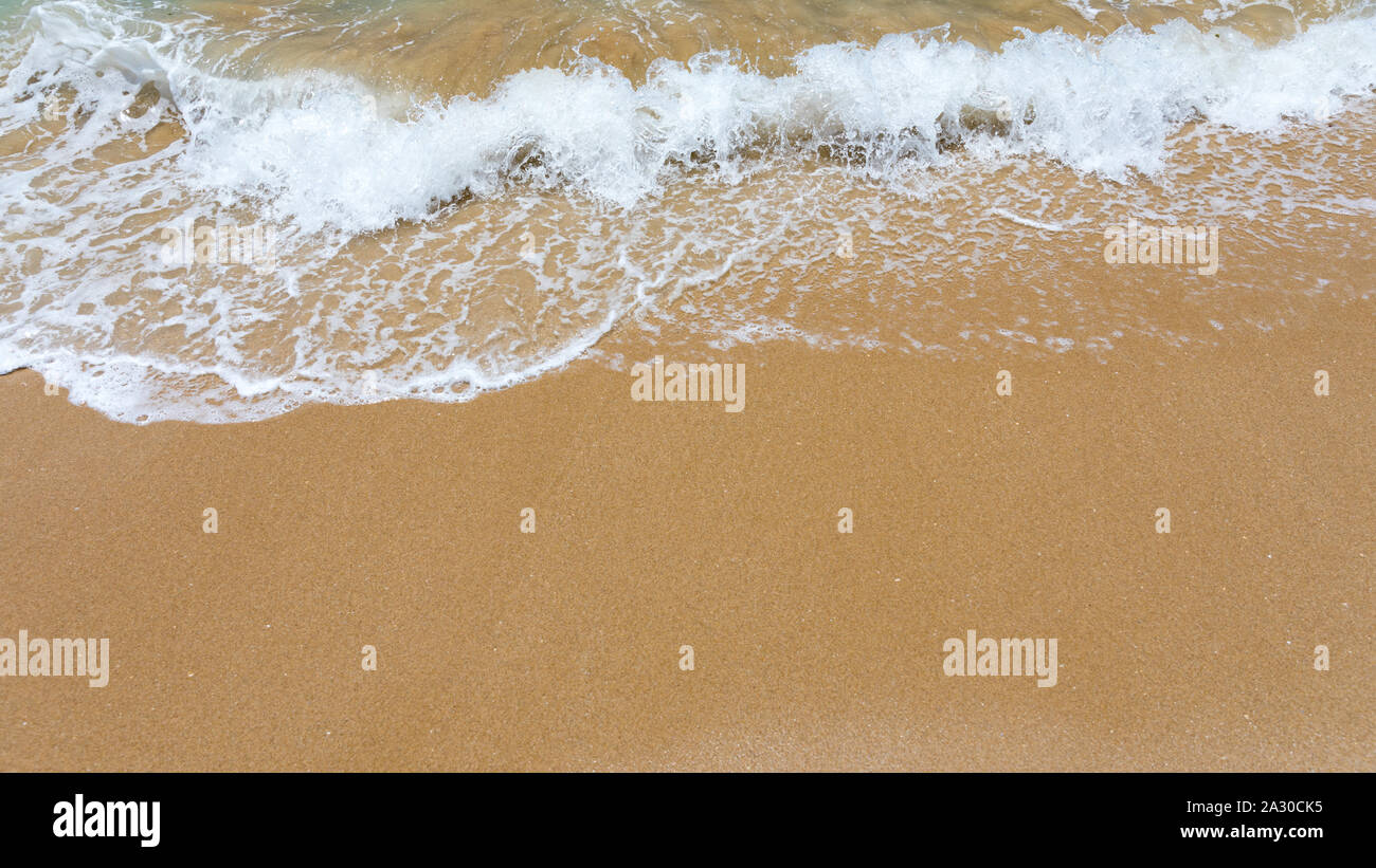 Blue ocean wave on sandy beach. Soft wave of blue ocean on sandy beach ...