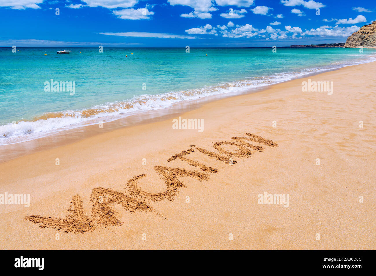 Vacation text on a beach. Vacation written in a sandy tropical beach ...