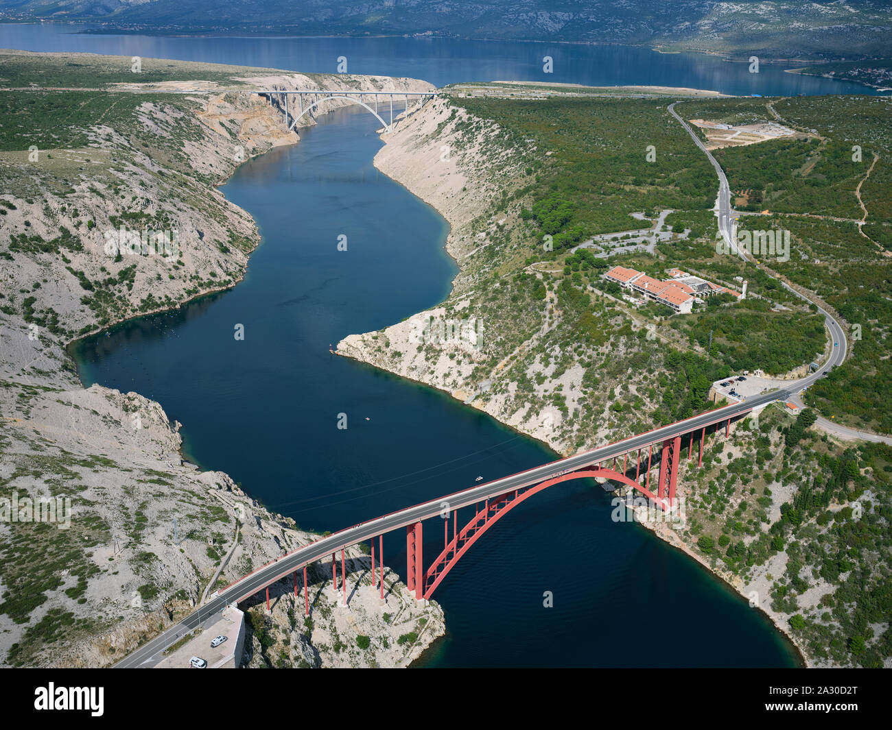 AERIAL VIEW. New Maslenica steel deck arch bridge spanning the natural ...