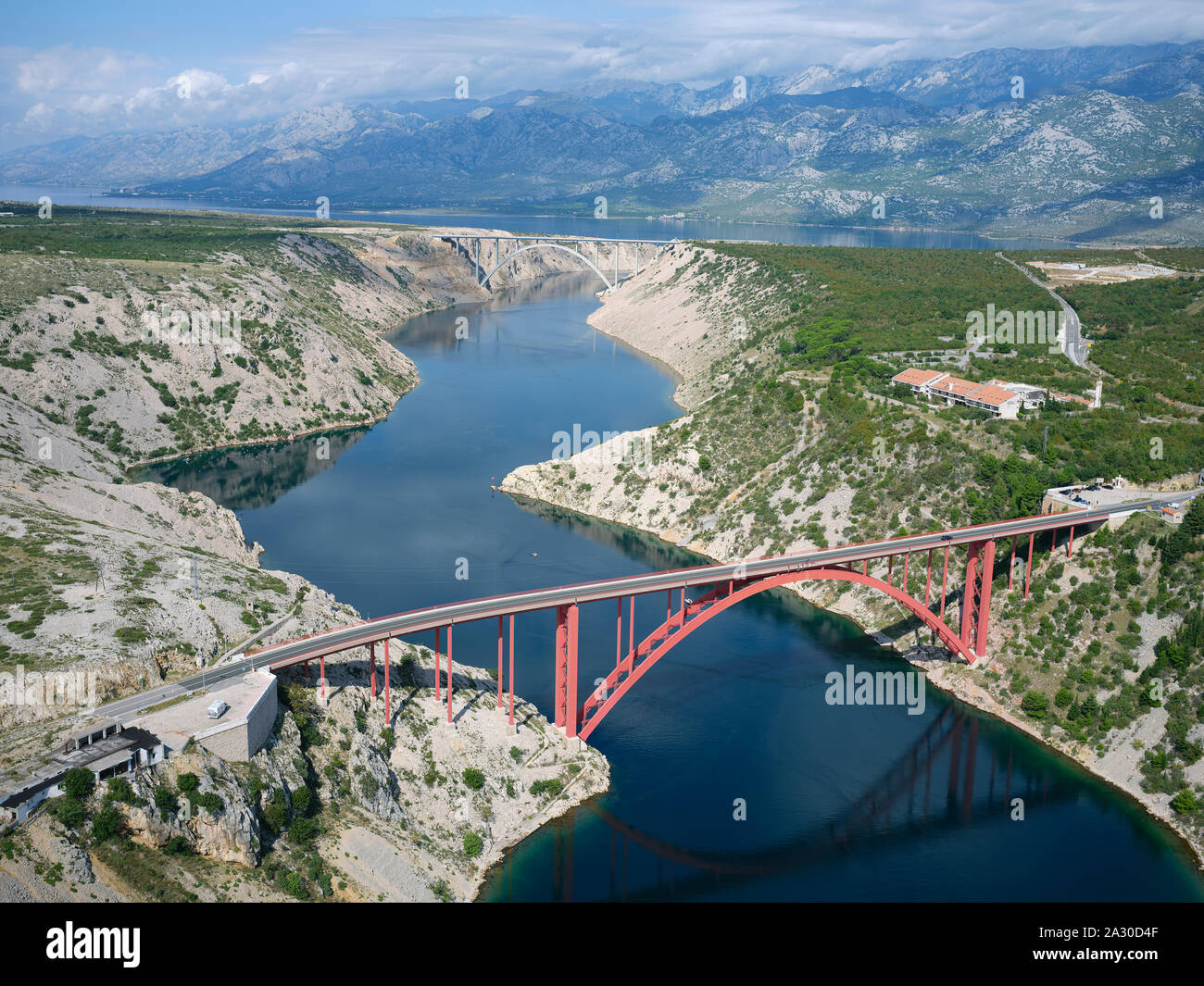 AERIAL VIEW. New Maslenica steel deck arch bridge spanning the natural ...