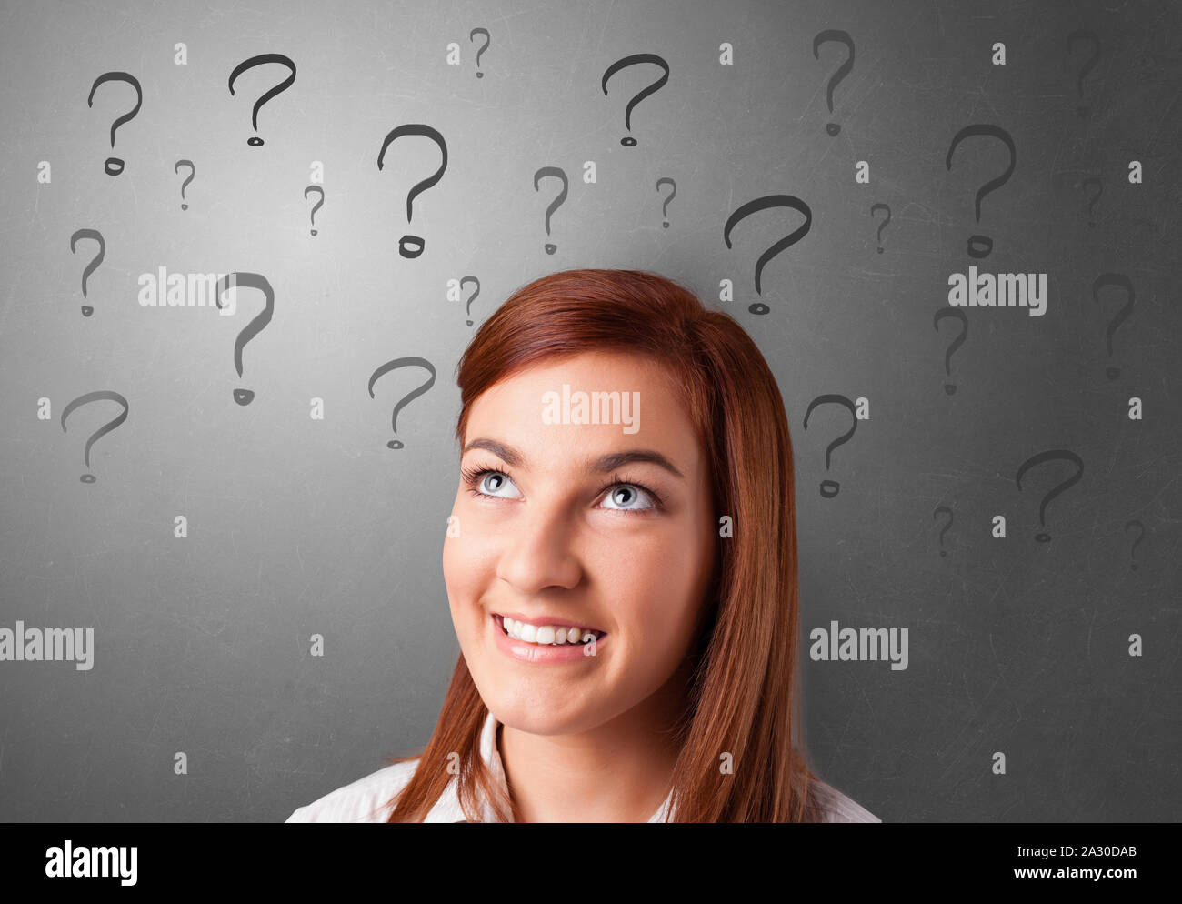 Person with question marks around face Stock Photo - Alamy