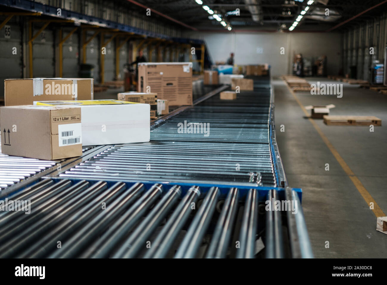 Conveyor line in warehouse Stock Photo - Alamy
