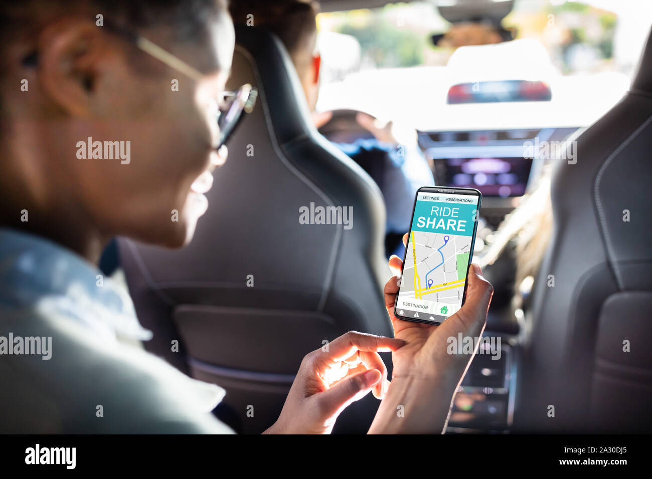 African Woman Using Car Sharing App While Sitting In Car Stock Photo ...
