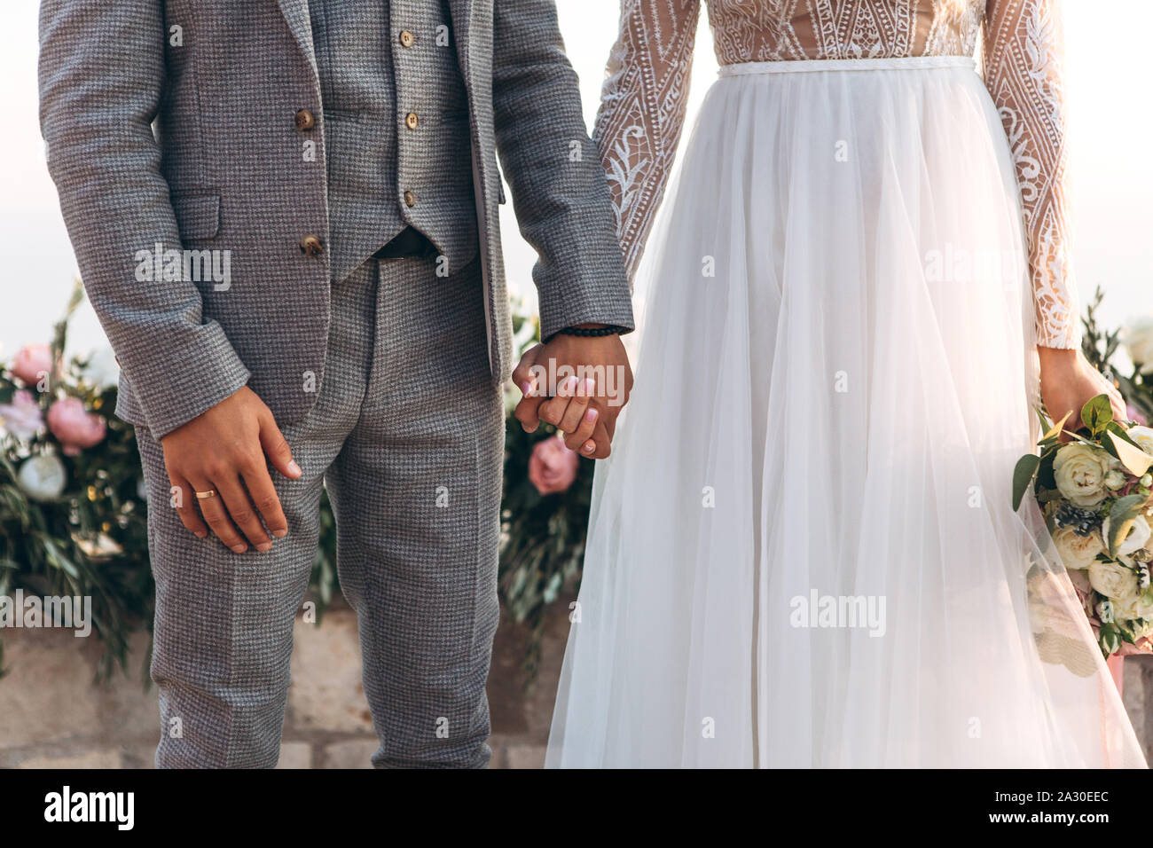 The bride and groom hold hands during the wedding ceremony Stock Photo ...