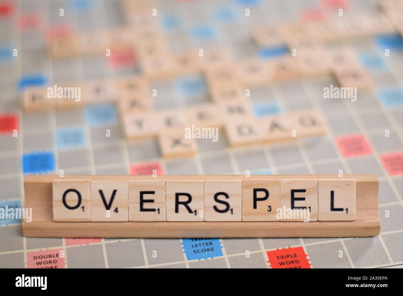 The Dutch word 'overspel' (in English: 'cheating') in wooden scrabble ...